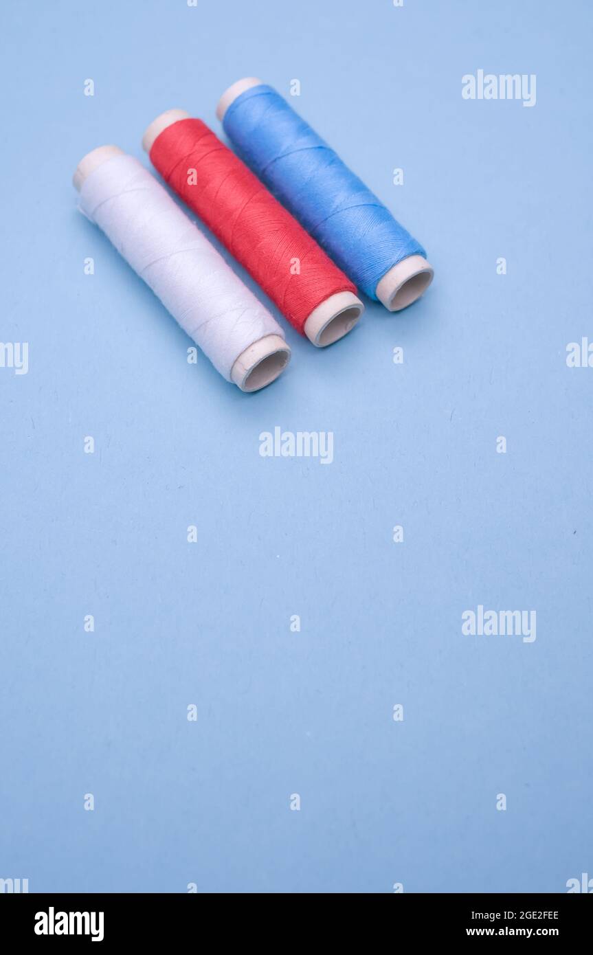 Vertical closeup of threads on the aesthetic blue background Stock ...