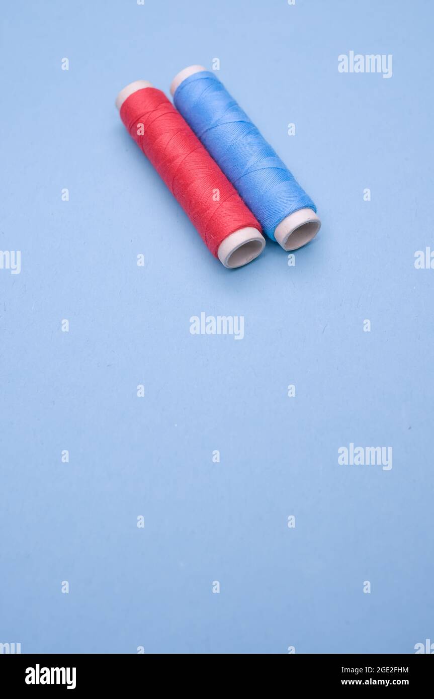 Vertical closeup of threads on the aesthetic blue background Stock ...