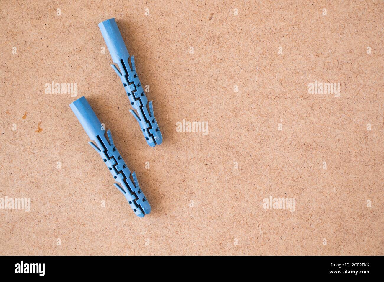 Blue plastic wall plugs on the brown background, high angle view Stock ...