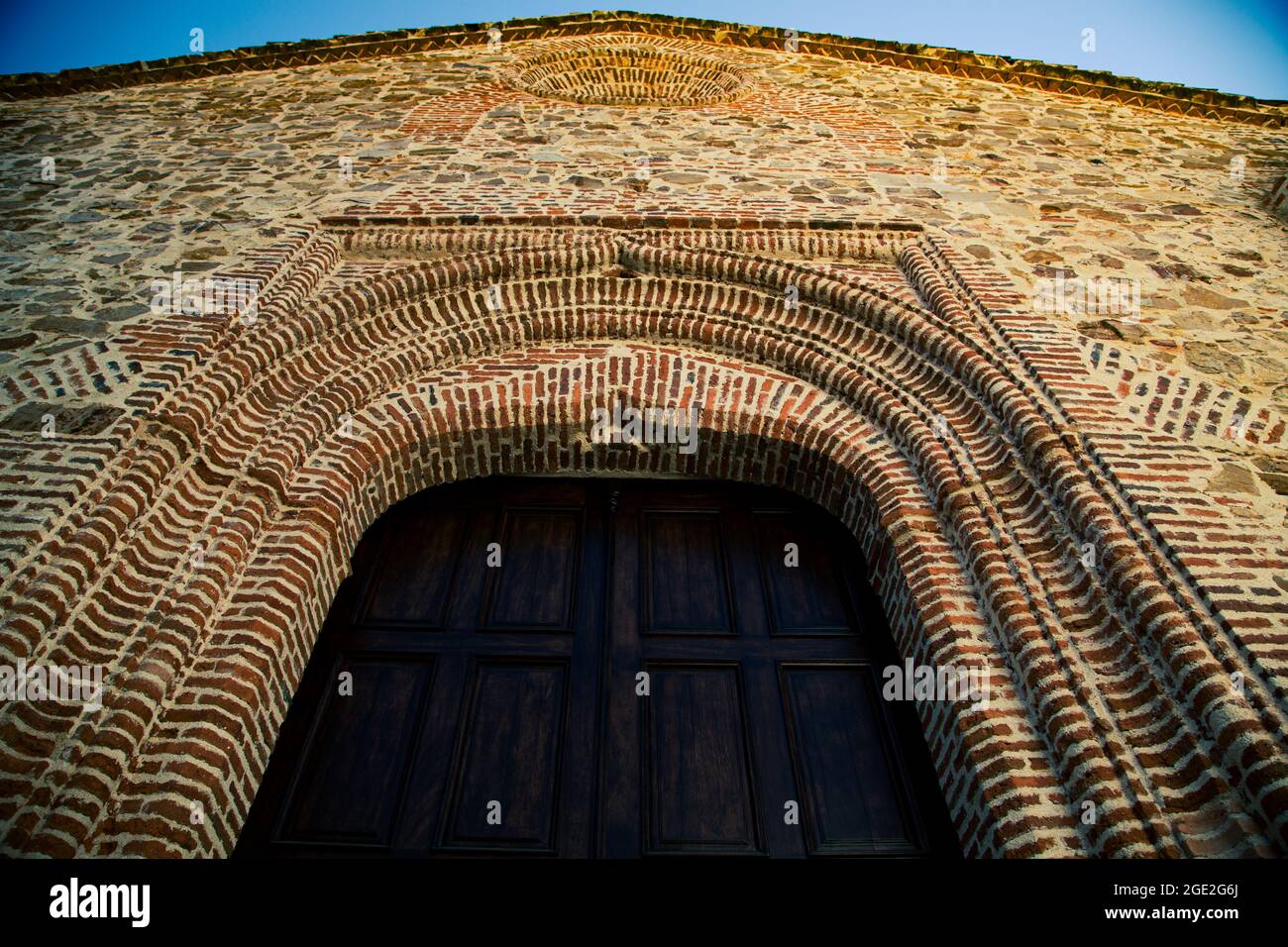 Facade of a Romanesque church with a large gate and facades with arches ...