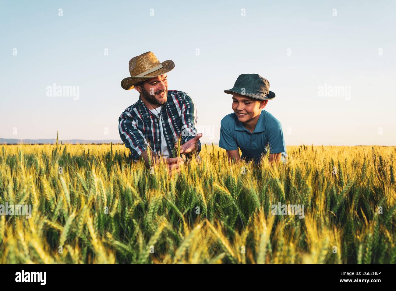 Father with son in agriculture field hi-res stock photography and ...