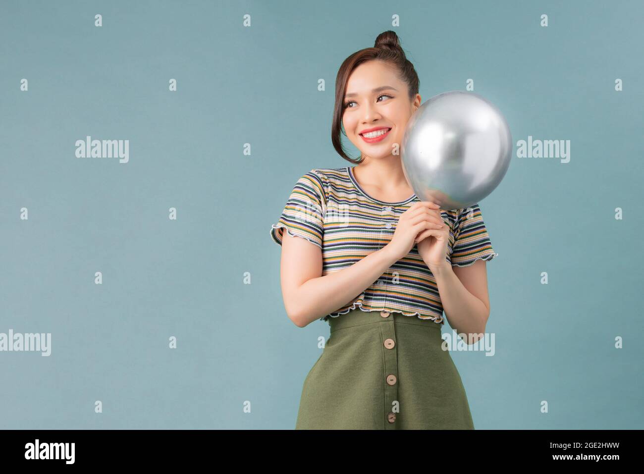 Woman hugging the Balloon on color background Stock Photo - Alamy