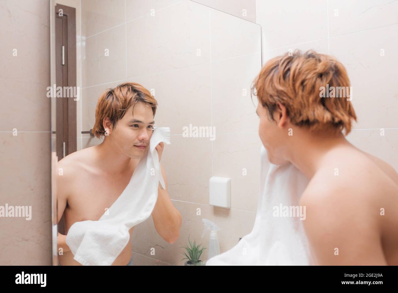Young man drying face towel hi-res stock photography and images - Alamy