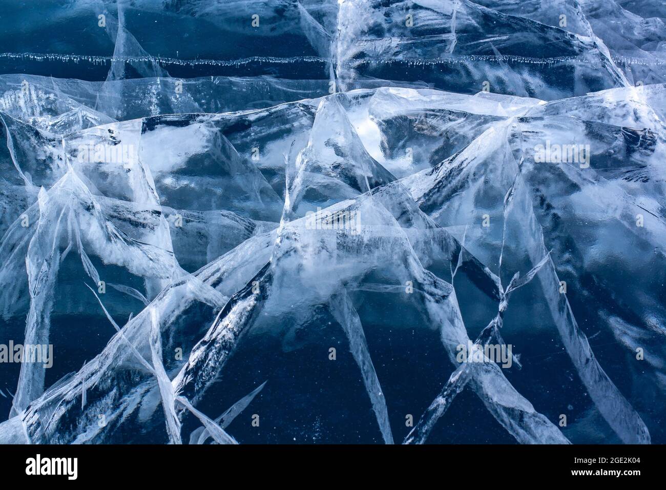 Transparent blue ice with many cracks. The ice is thick. Horizontal ...