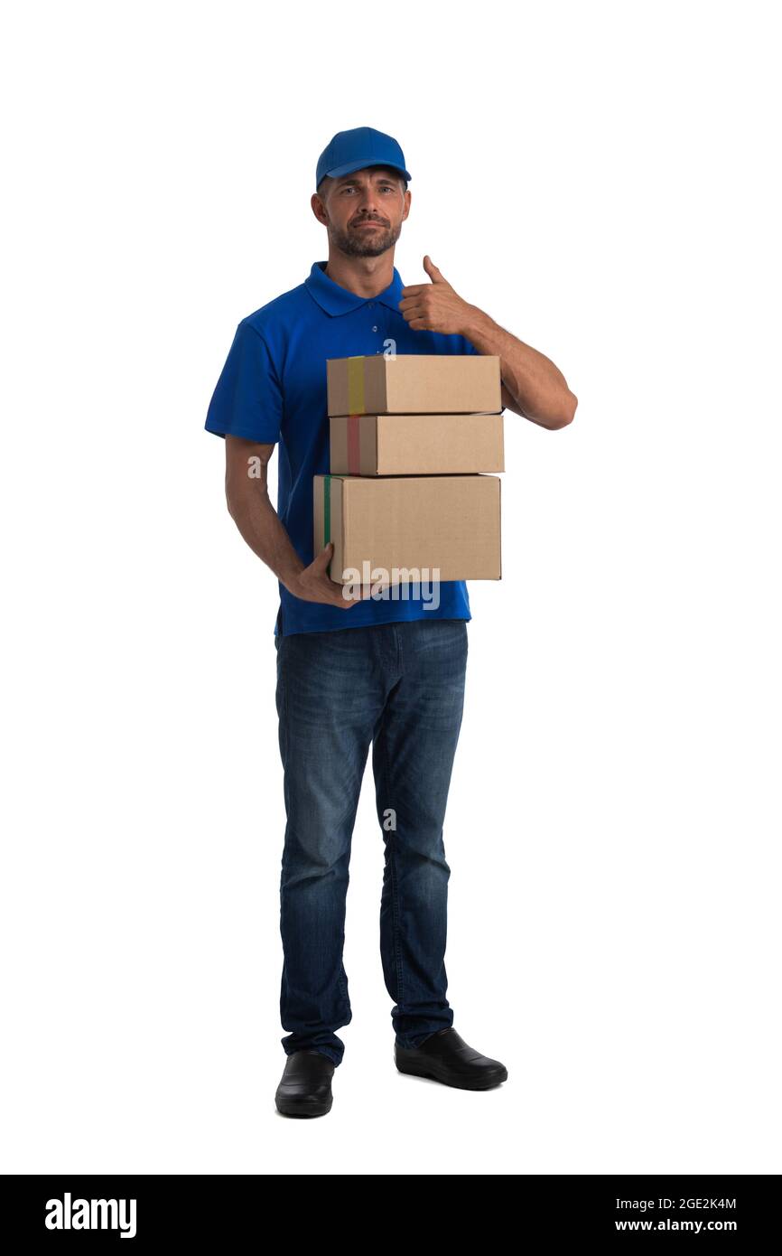 Smiling young post employee with parcels giving thumb up isolated on ...