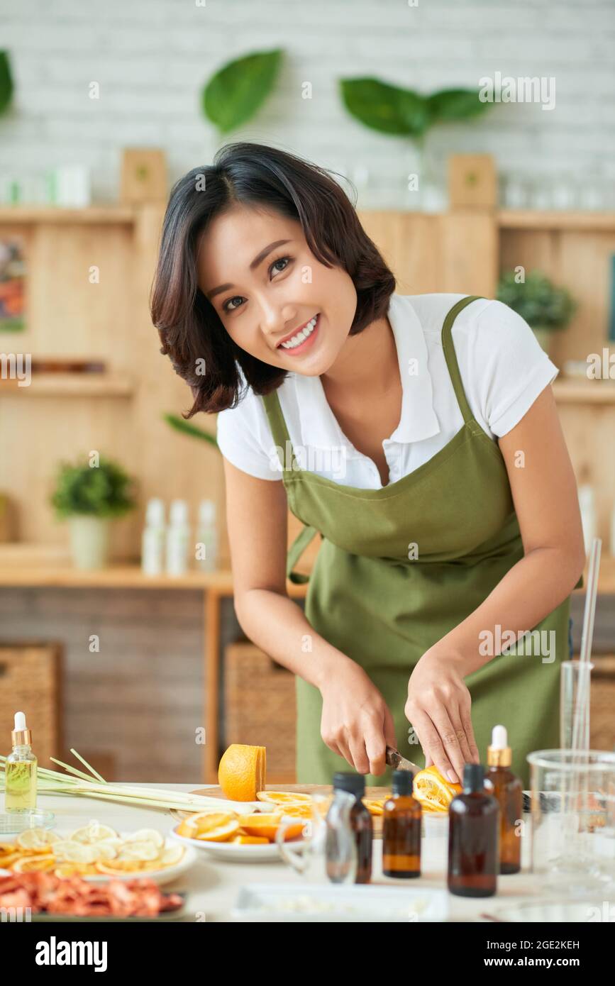 Portrait of pretty smiling young woman preparing ingredients for making ...
