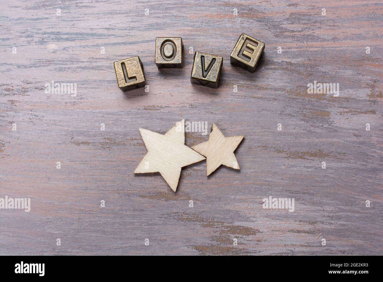 Word LOVE and wooden stars on a surface with faded paint Stock Photo ...
