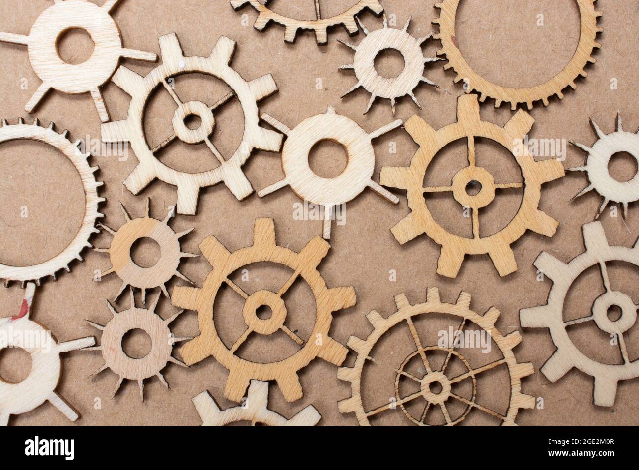 Wooden gears on a brown back Stock Photo - Alamy