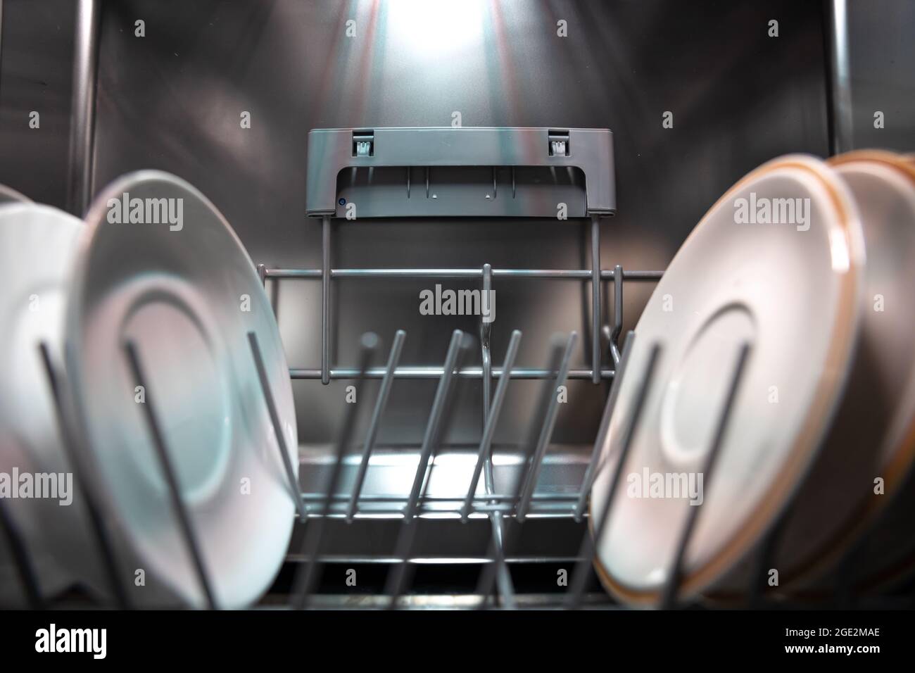 Close up of clean plates inside the dishwasher Stock Photo - Alamy