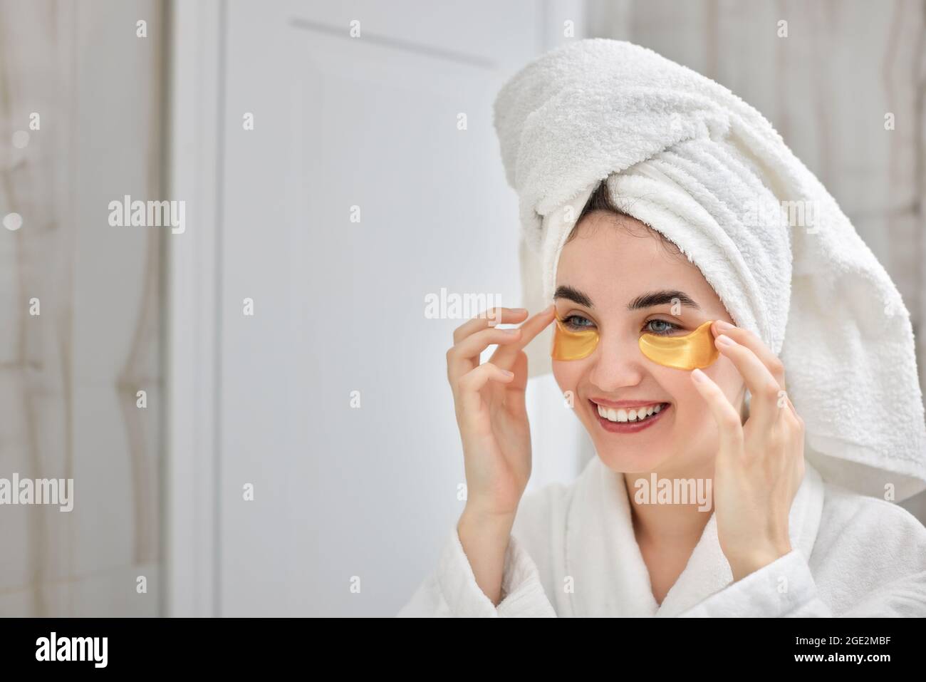 Beautiful Woman With Eye Patches In White Bathrobes In Bathroom Stock