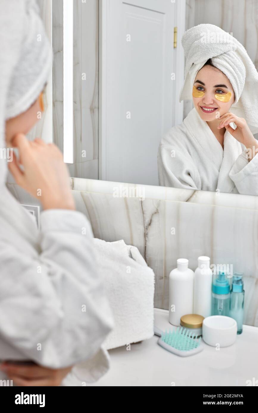 Beautiful Woman With Eye Patches In White Bathrobes In Bathroom Stock