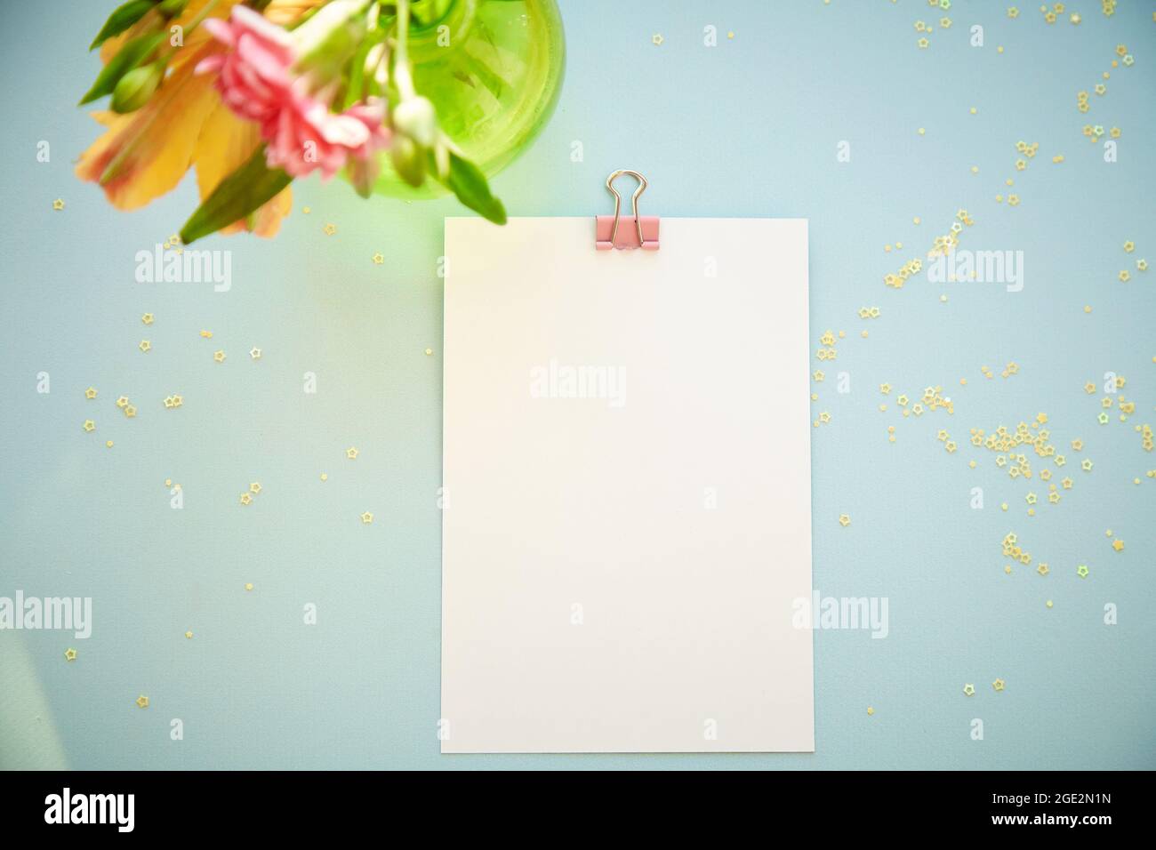 Festive postcard mock up on blue background with flowers. Top view. 1st ...