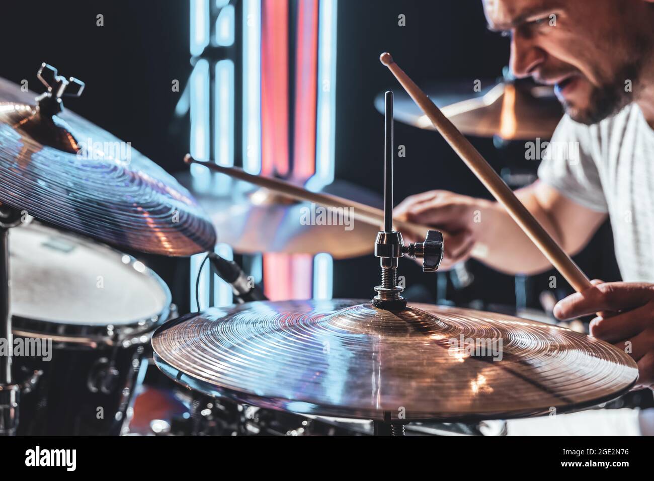 Close-up of drum cymbals as the drummer plays with beautiful lighting ...