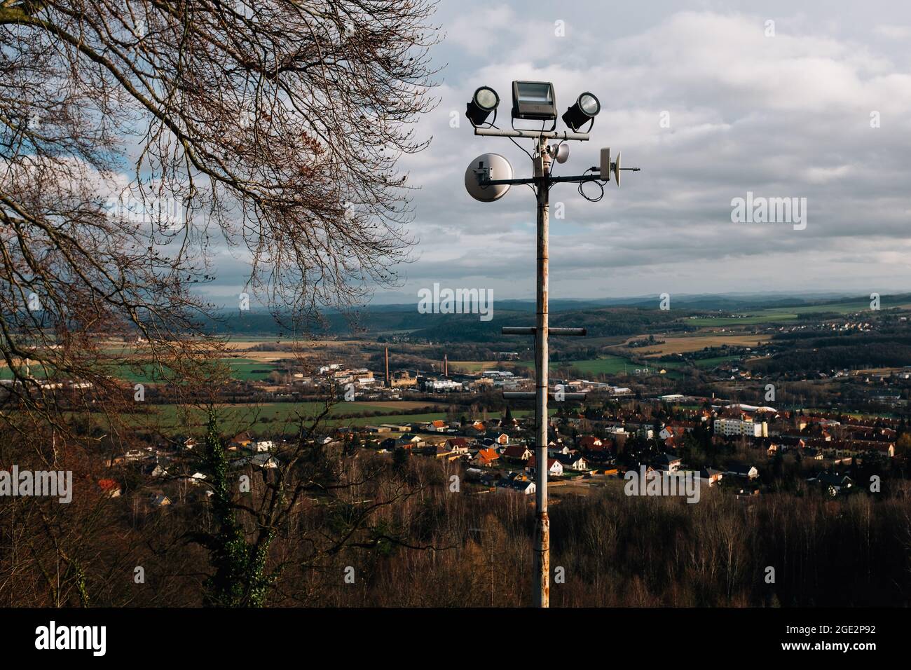 Street light in a park with a view of a town under the cloudy sky Stock ...