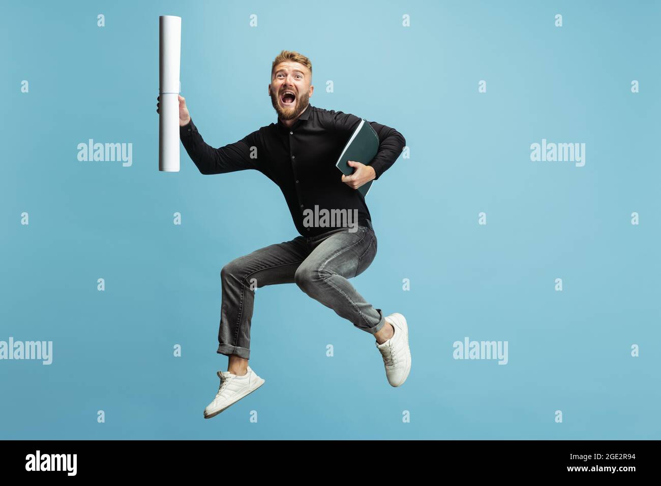 Funny portrait of young bearded man, builder, designer or architect ...