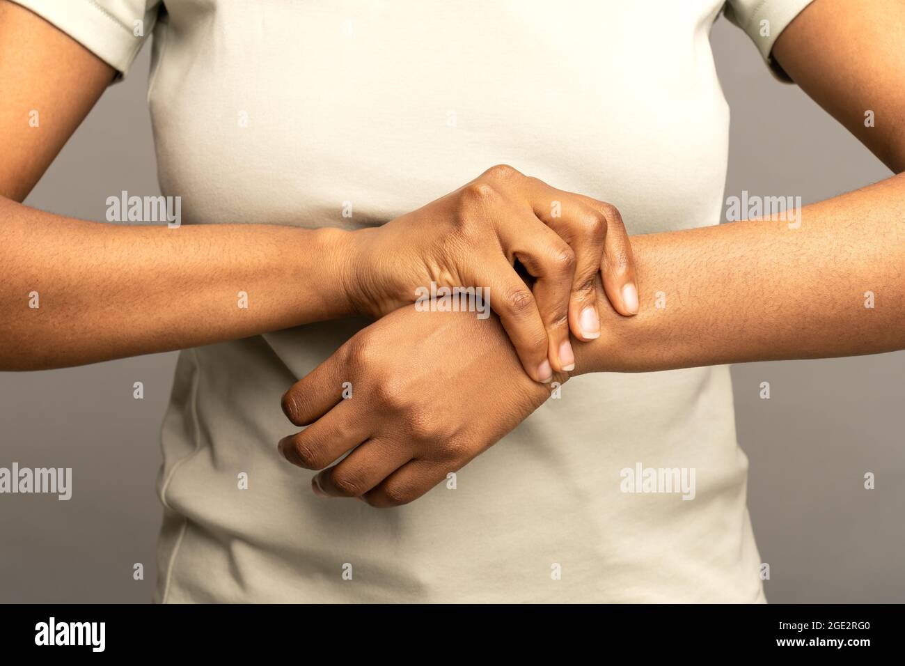 Black female arms massaging painful wrist suffering from weakness and ...