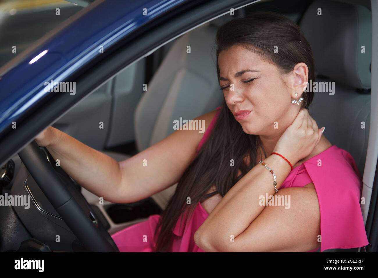 Woman suffering from neck pain, tired after long driving Stock Photo ...
