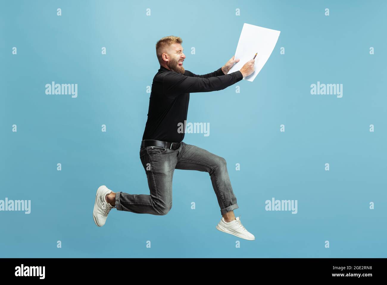 Funny portrait of young bearded man, builder, designer or architect ...