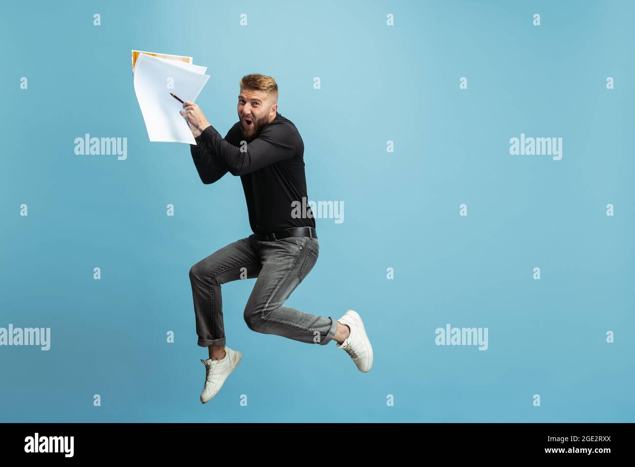 Funny portrait of young bearded man, builder, designer or architect ...