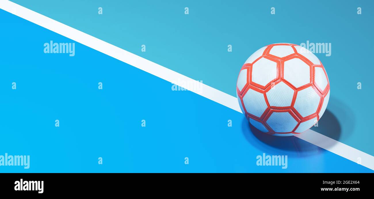 White and orange futsal ball on the indoor soccer field background with ...