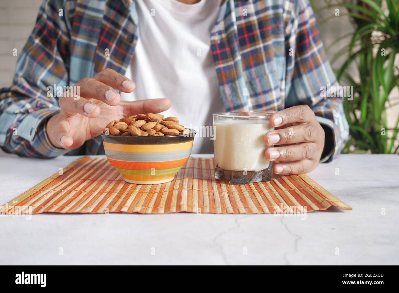 Young man eating almond hi-res stock photography and images - Alamy