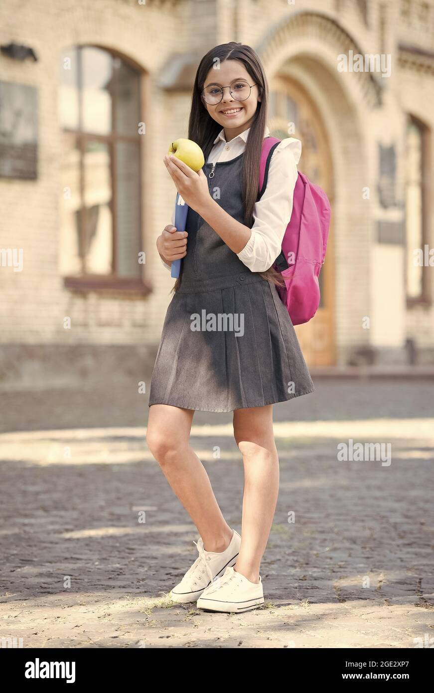 Have you had your break today. Little child hold apple outdoors. School ...