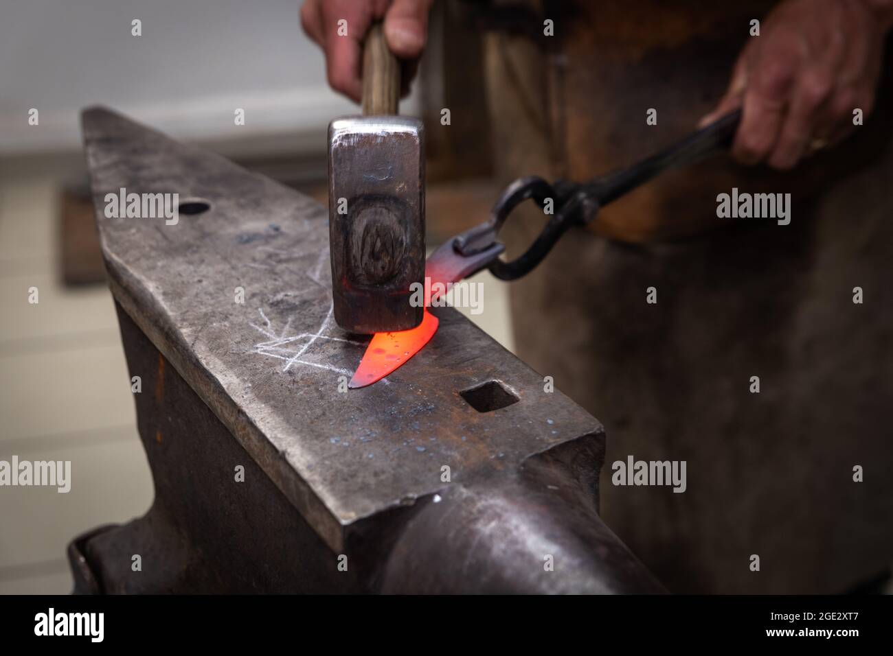 two man hands are manufacturing a steel knife Stock Photo - Alamy