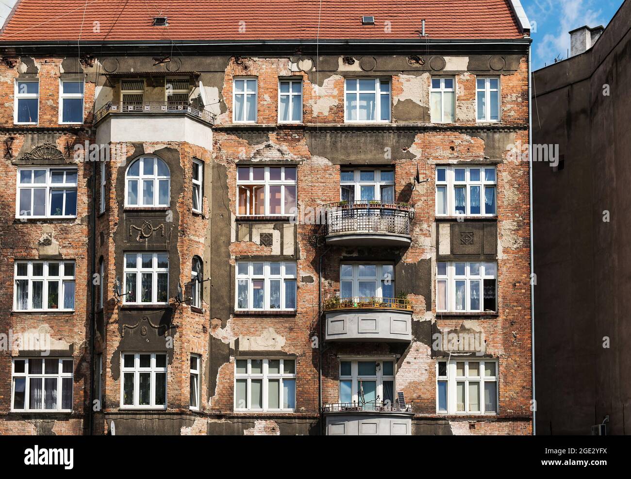 Shabby cracked building facade, old windows. Front Facade of old ...