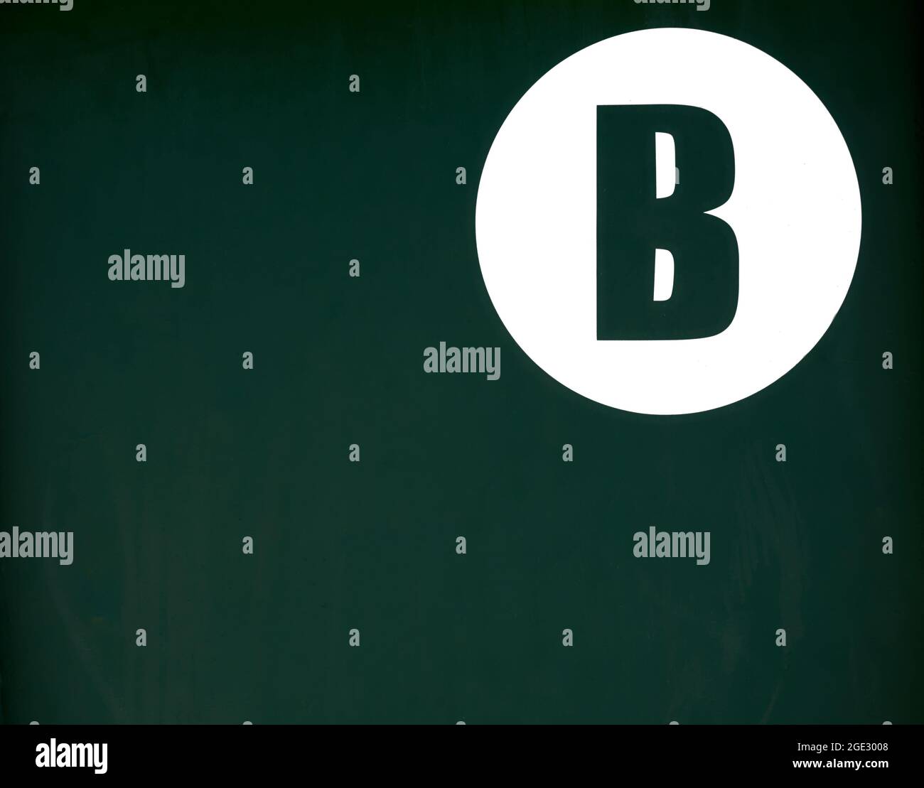 detail of the letter b inside a white circle on a green metal ...