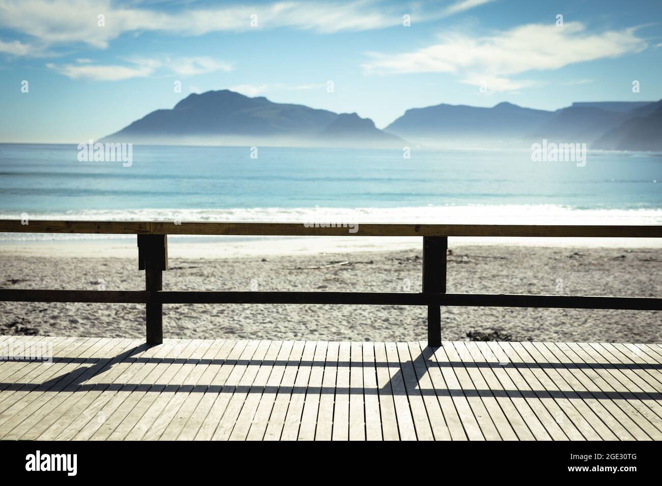 Promenade with mountains in background on sunny day by seaside Stock ...