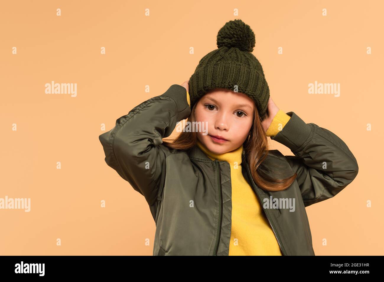kid in brown hat and jacket posing with hands behind head isolated on ...