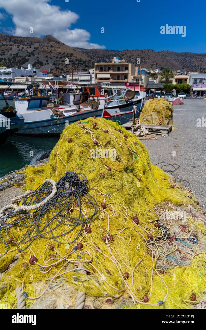 Nets and traditional fishing boats at a small harbor on the Greek ...