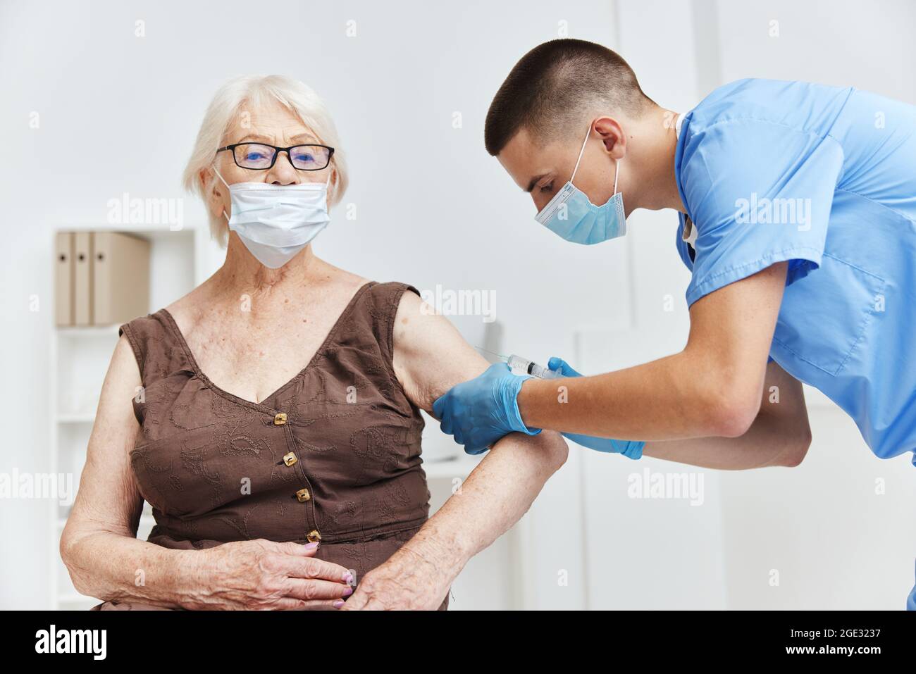 male doctor giving an injection immunization safety patient treatment ...