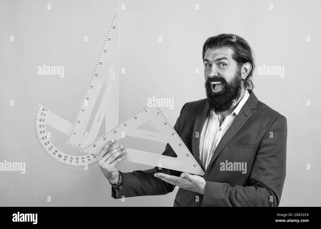 teacher of arithmetic with happy face holding protractor and triangle ...
