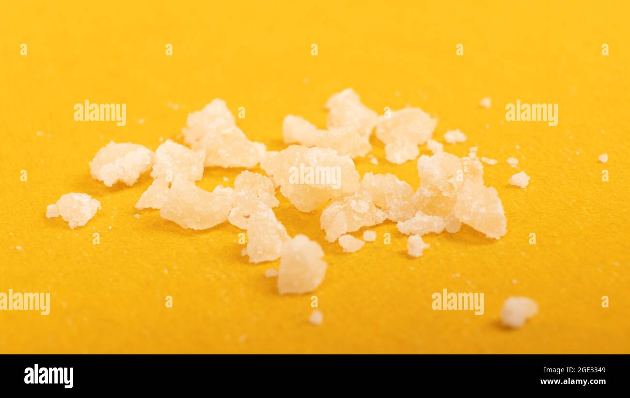 crystal pieces wax of marijuana concentrate, cannabis dab on yellow ...