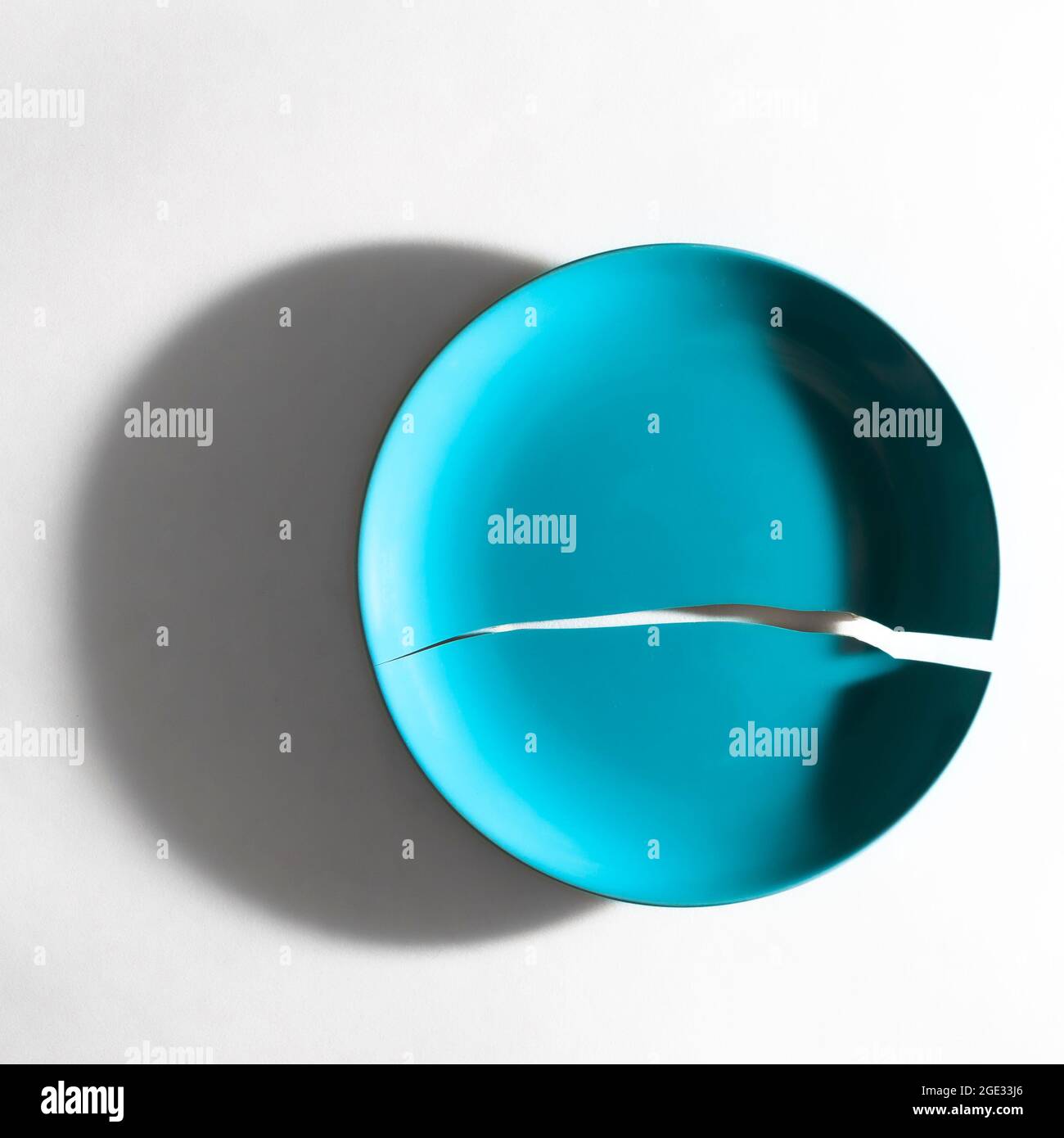 Rift - the beginning; Crack in blue plate on white background, rift ...