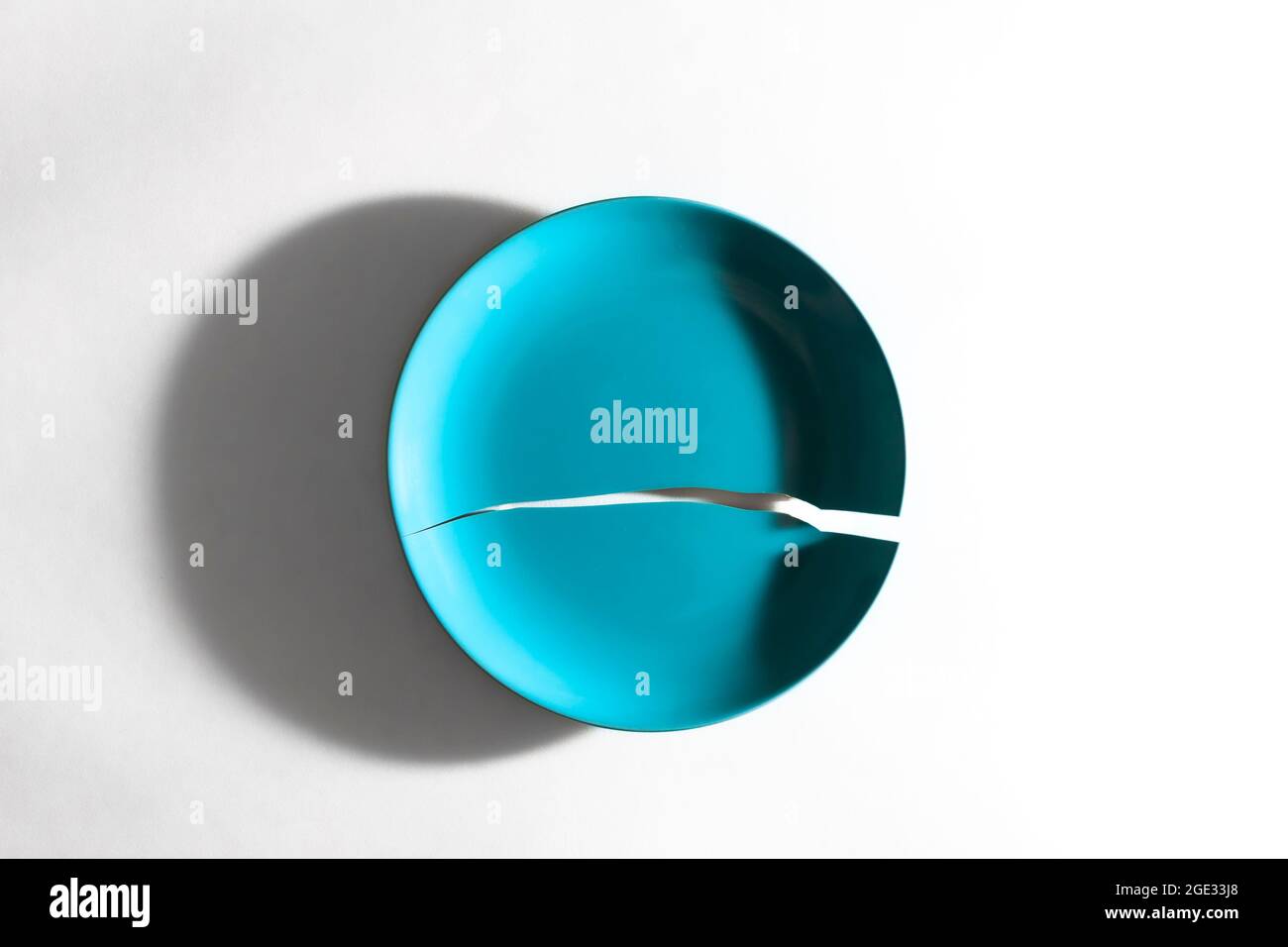 Rift - the beginning; Crack in blue plate on white background, rift ...