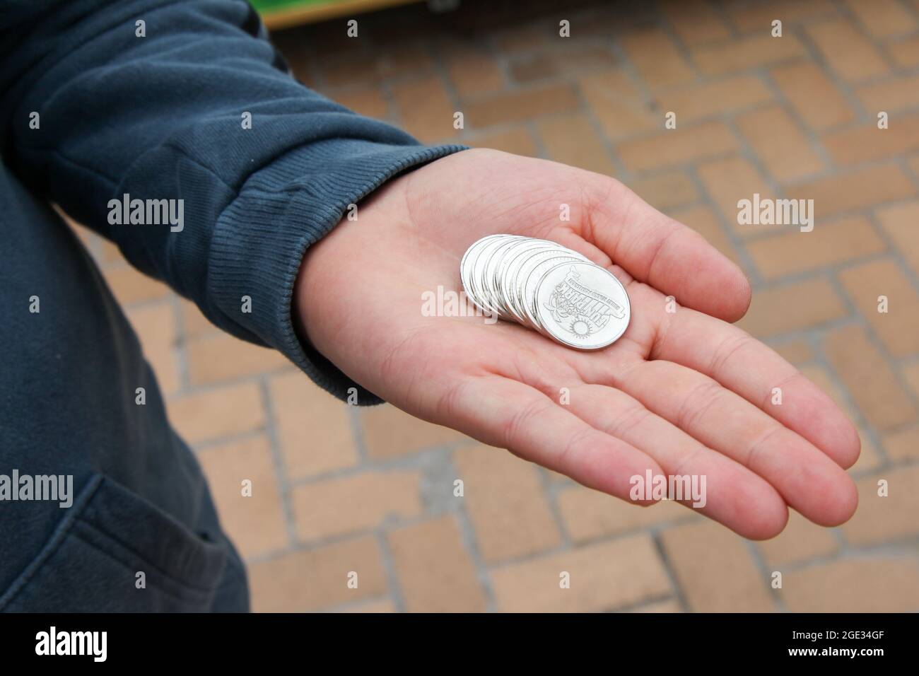 hand with tokens for Fun Park amusements, Barry Island Promenade, South ...
