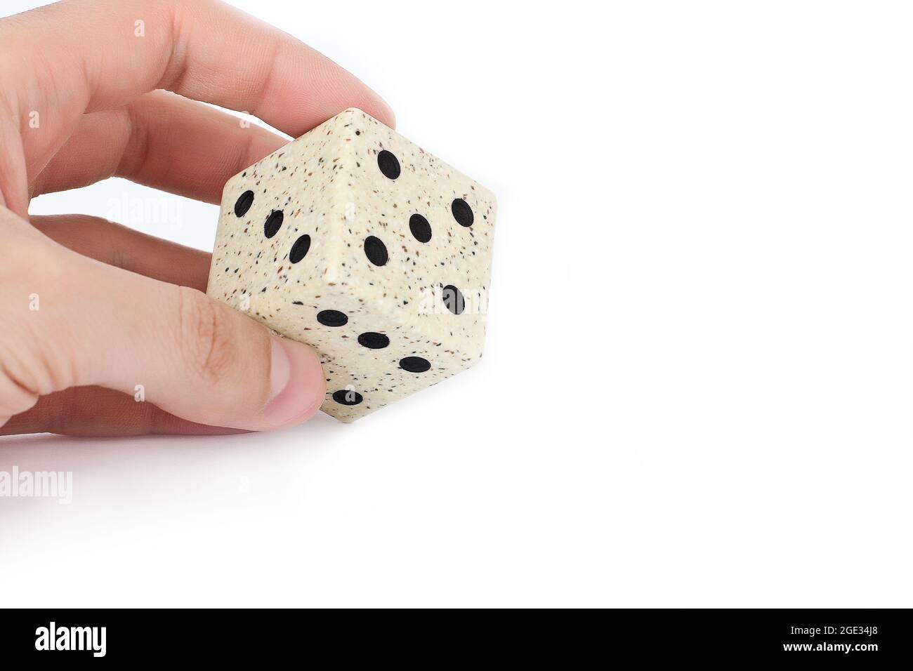 Dice in hand on white background Stock Photo - Alamy