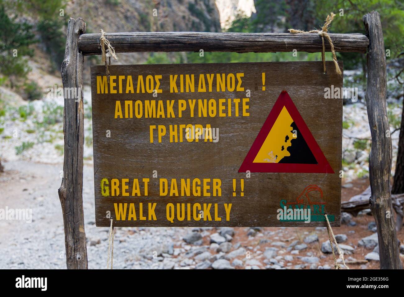 A sign warning of "Great Danger" advising people to "Walk Quickly" due ...
