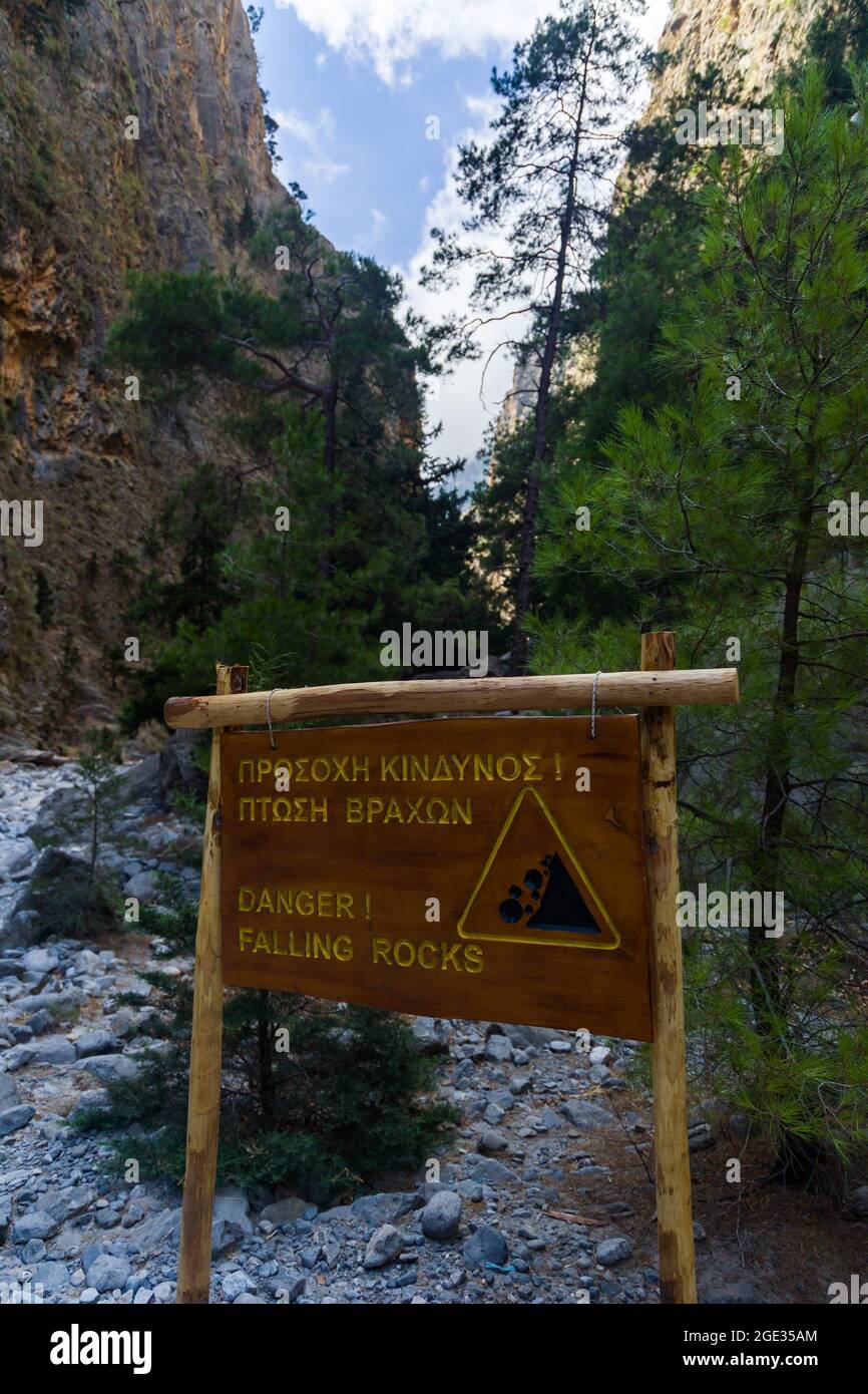 A sign warning of "Great Danger" advising people to "Walk Quickly" due ...