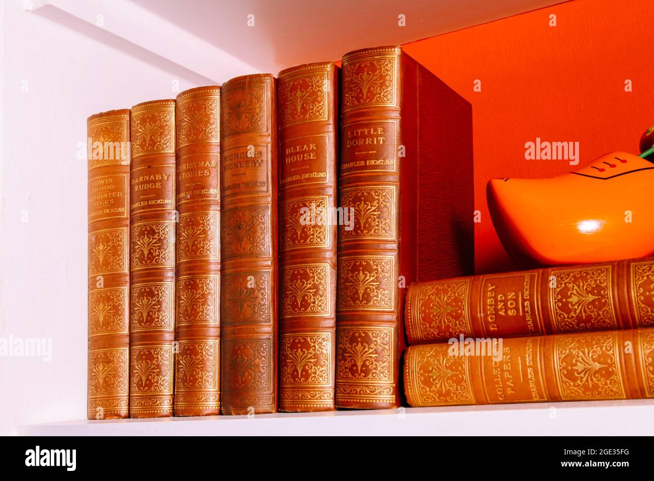 A collection of William Shakespeare novels on book shelf with clog ...