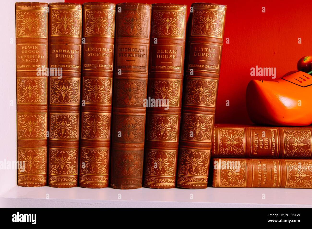 A collection of William Shakespeare novels on book shelf with clog ...