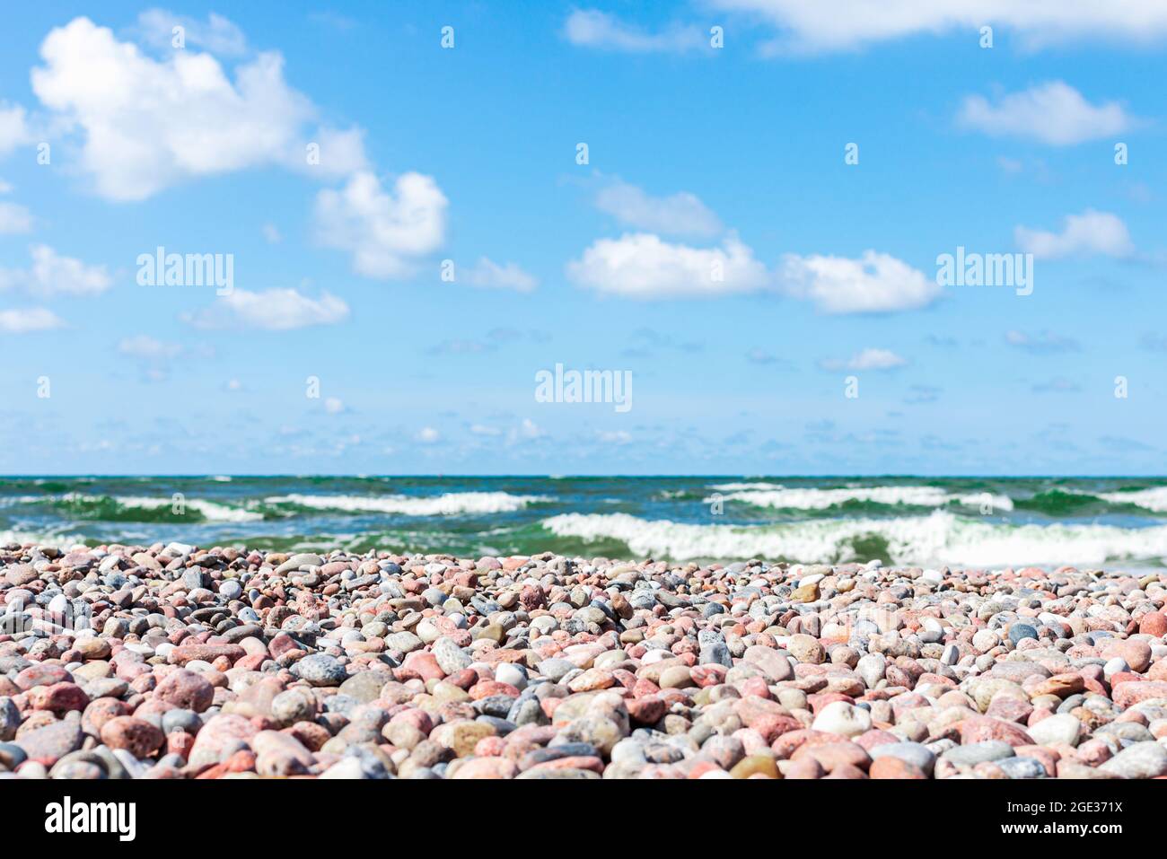 Small pebbles on the shore. sunny summer day blue sky,white clouds ...