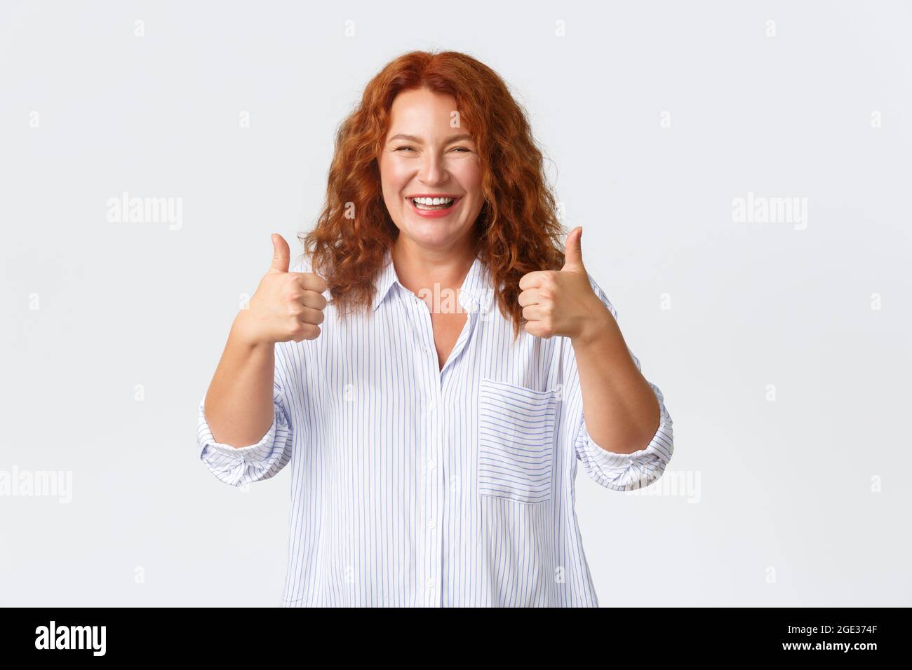 Good job, nice work gesture. Portrait of pleased smiling redhead middle ...