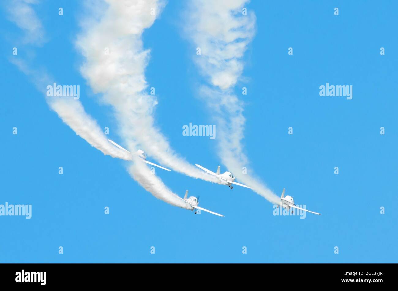 Light engine airplane with a trace of white smoke fly in groups in the ...