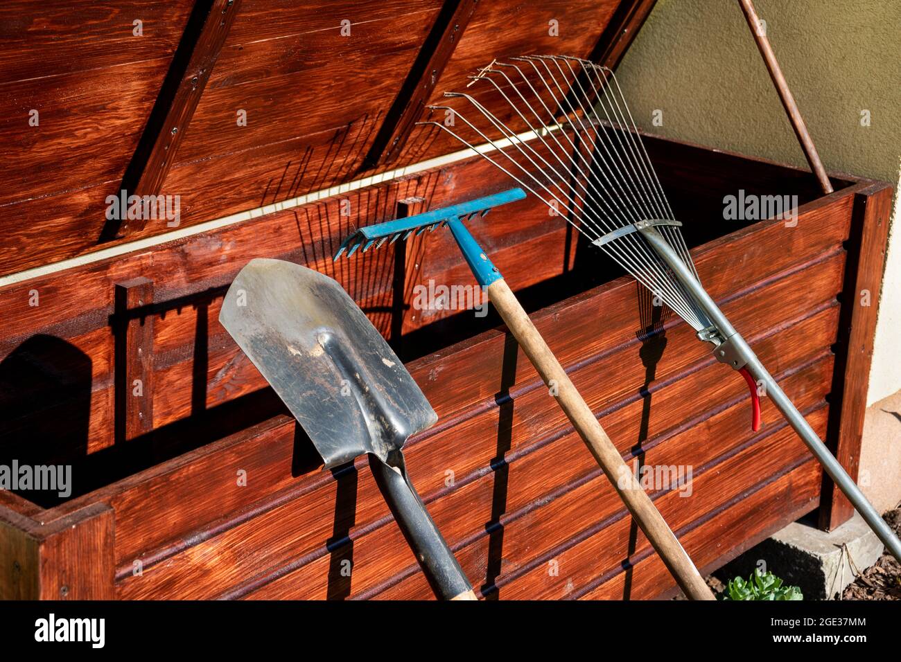 Case for garden tools - rake, spade, broom. Selfmade garden chest Stock ...