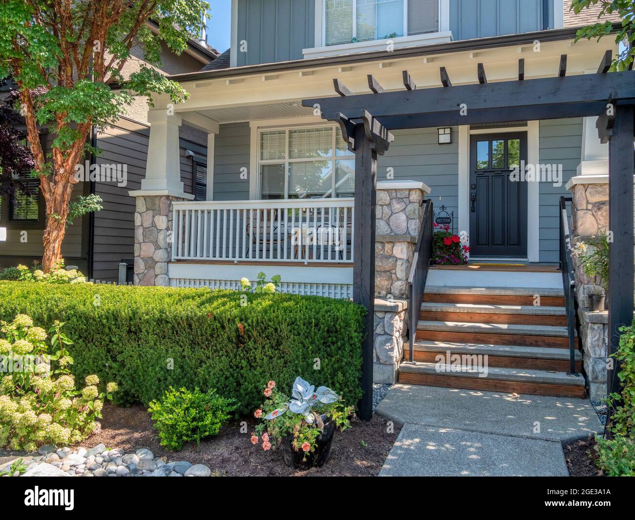 A perfect neighbourhood. Porch and entrance of residential house Stock ...