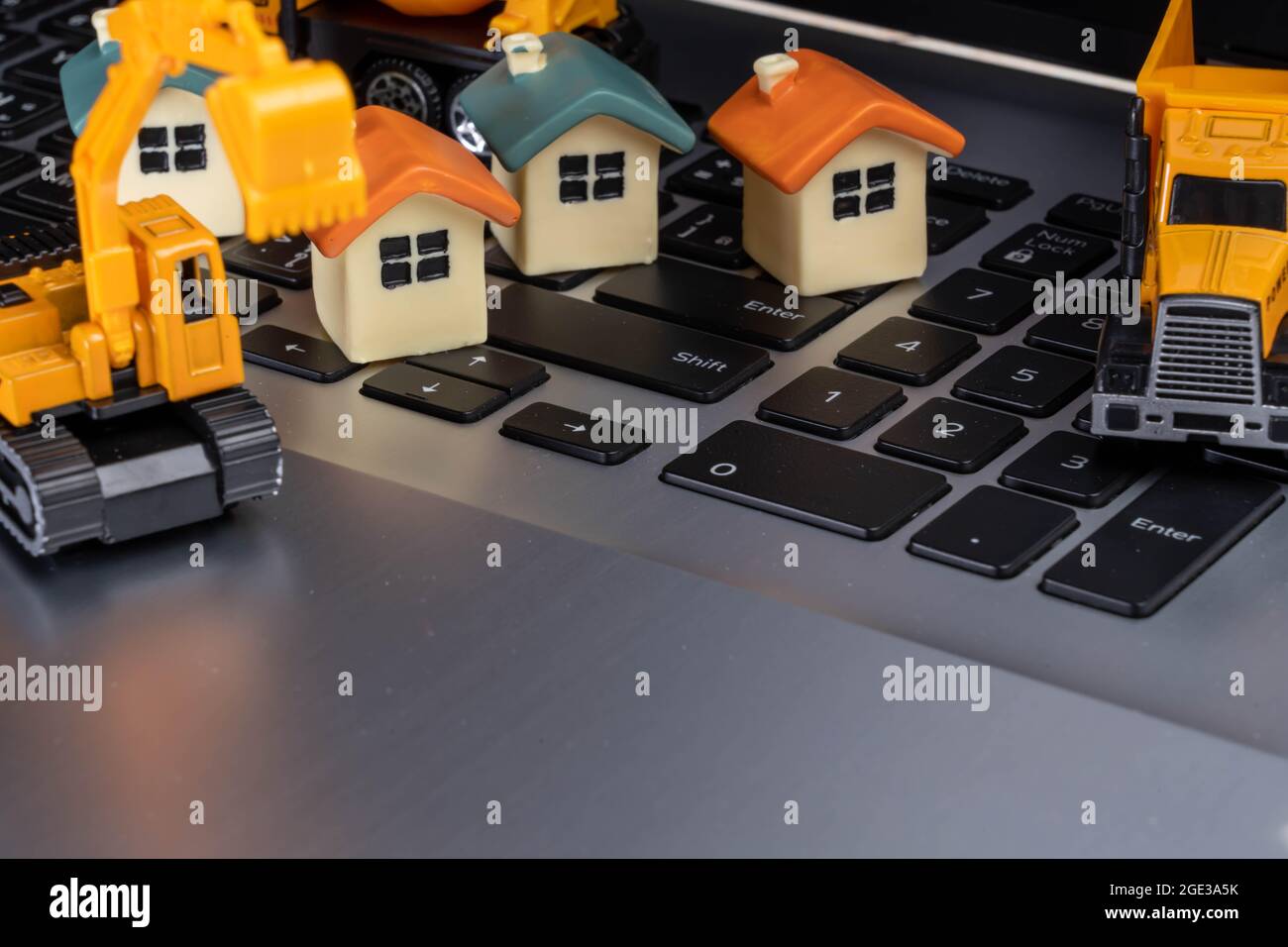 Home model and construction vehicles on PC Stock Photo - Alamy