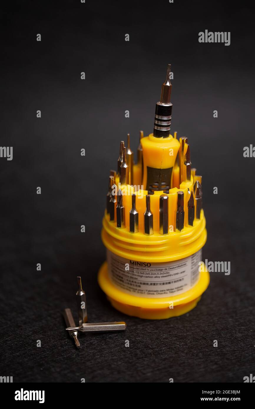 a set of yellow screwdrivers on a black background Stock Photo - Alamy